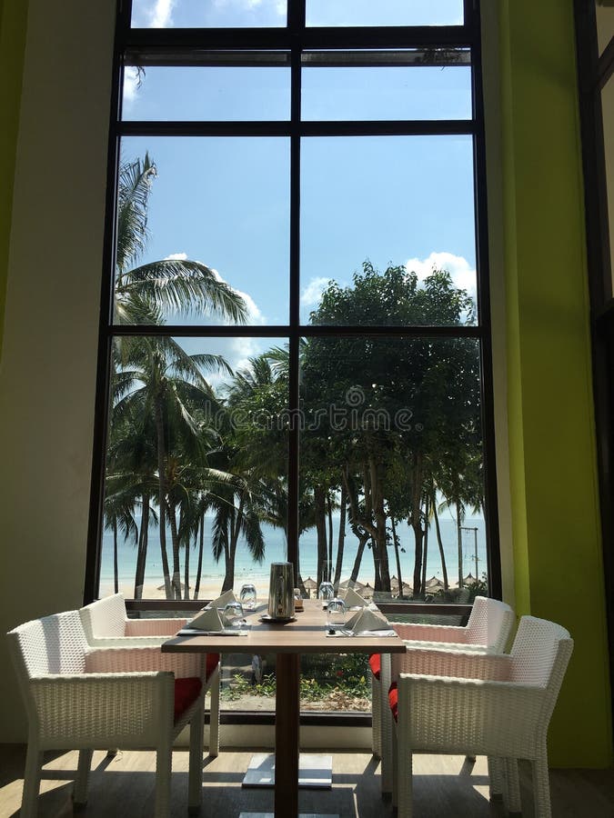 Table in Front of a Window with Beach View Stock Image - Image of ...