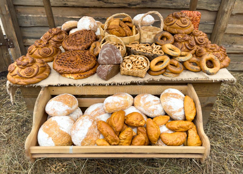 A Table Full of Different Types of Bread and Pastries Stock Photo ...