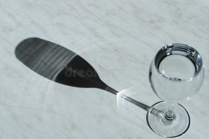On the Table is a High-stemmed Glass of Water. the Object Casts a ...