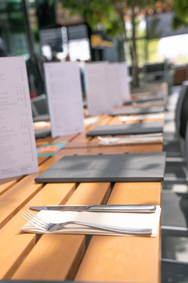 Table with Cutlery and Menu in a Restaurant. Stock Image - Image of ...
