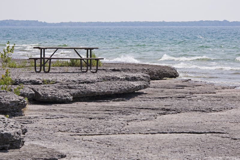 Table on a lakeshore stock photo. Image of table, water - 76575508