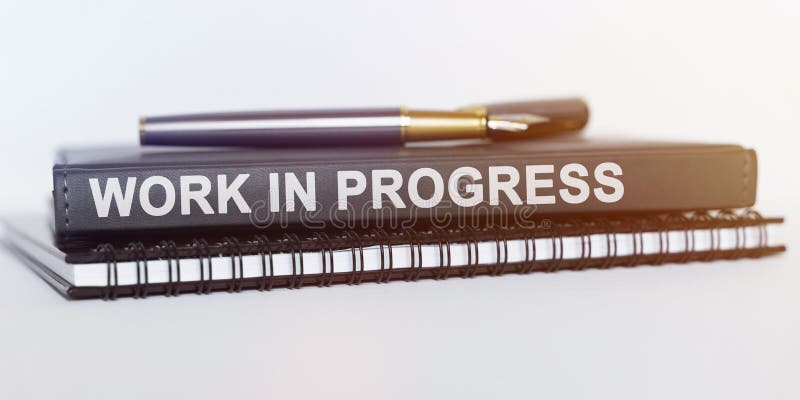 On the Table are a Notebook, a Pen and a Book. the Book Says - WORK in ...