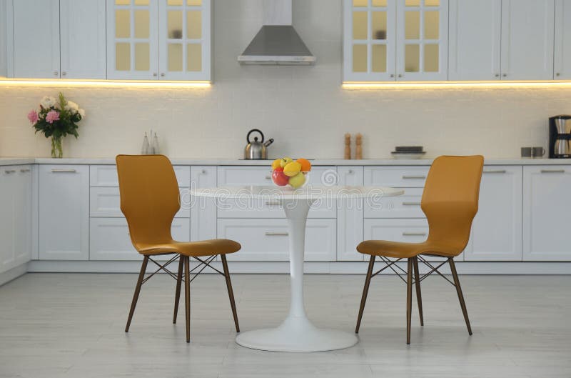 Table with Orange Chairs in Kitchen Interior Stock Photo - Image of ...