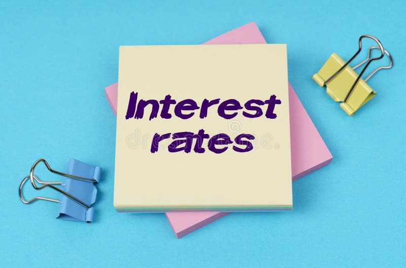 On the Table are Paper Clips, Note Paper with Text - Interest Rates ...