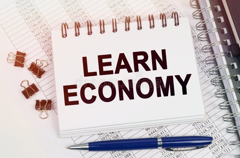 On the Table is a Pen and a Notebook with Inscriptions - LEARN ECONOMY ...