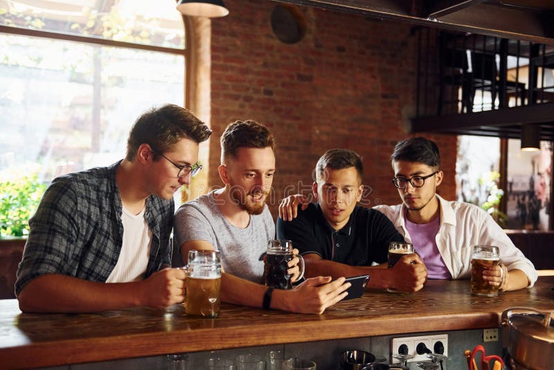 By the Table. People in Casual Clothes Sitting in the Pub Stock Image ...