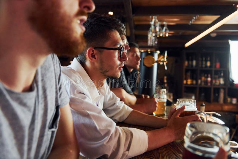 By the Table. People in Casual Clothes Sitting in the Pub Stock Photo ...