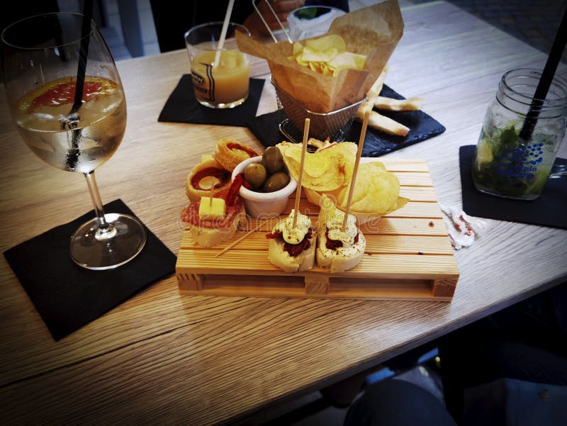Table with Platters of Aperitifs with Snacks and Drinks To Drink in a ...