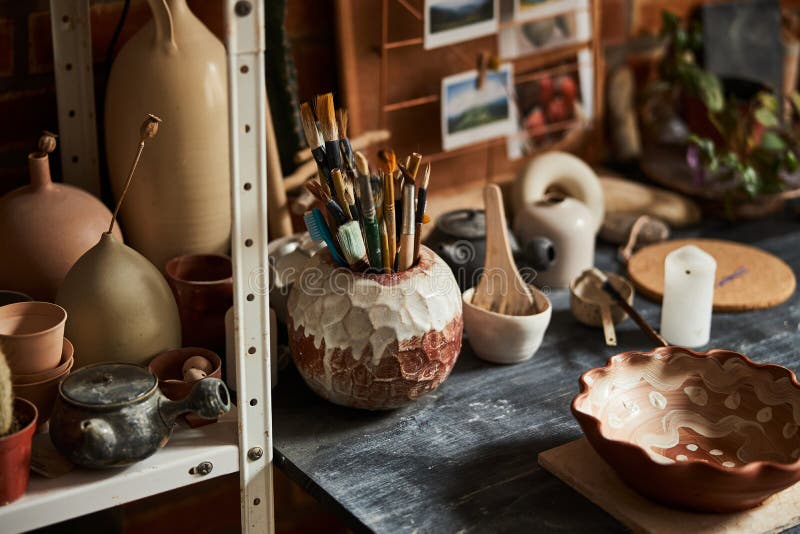 Handmade Pottery and Grinding Block on Table in Workshop Stock Photo ...