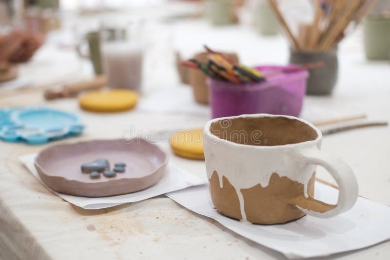 Table in a Pottery Workshop during a Master Class. Mug and Plate Made ...