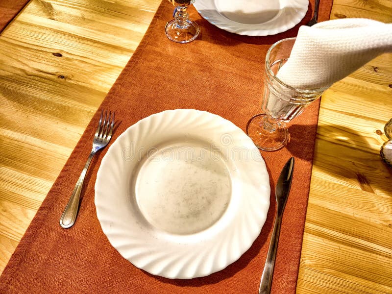 Empty Dining Table Setting with Elegant Plates and Glassware on a ...