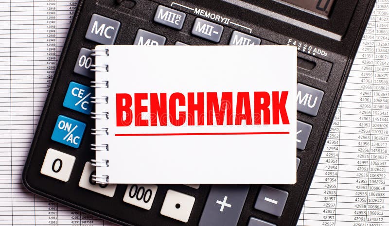 On the Table are Reports, a Calculator and a Card with the Word ...