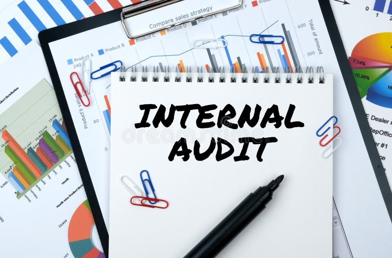 On the Table are Reports, Charts, a Notebook with the Inscription ...