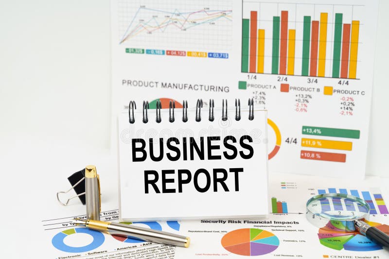 On the Table are Reports with Graphs and a Notepad with the Inscription ...