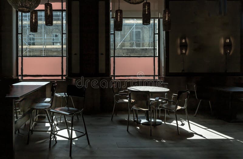 Table at a Restaurant with Sunlight Coming in through the Large Windows, Casting Light and ...