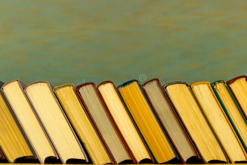 On the Table a Series of Books Tilted To the Left. Stock Image - Image ...