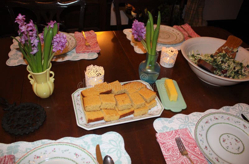 A Table is Set for a Meal that Includes Cornbread and Salad Stock Photo ...