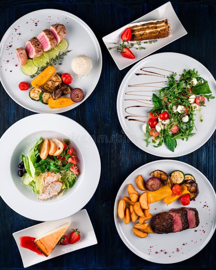 Table Set for Two with a Main Course, Salad and Dessert Stock Image ...