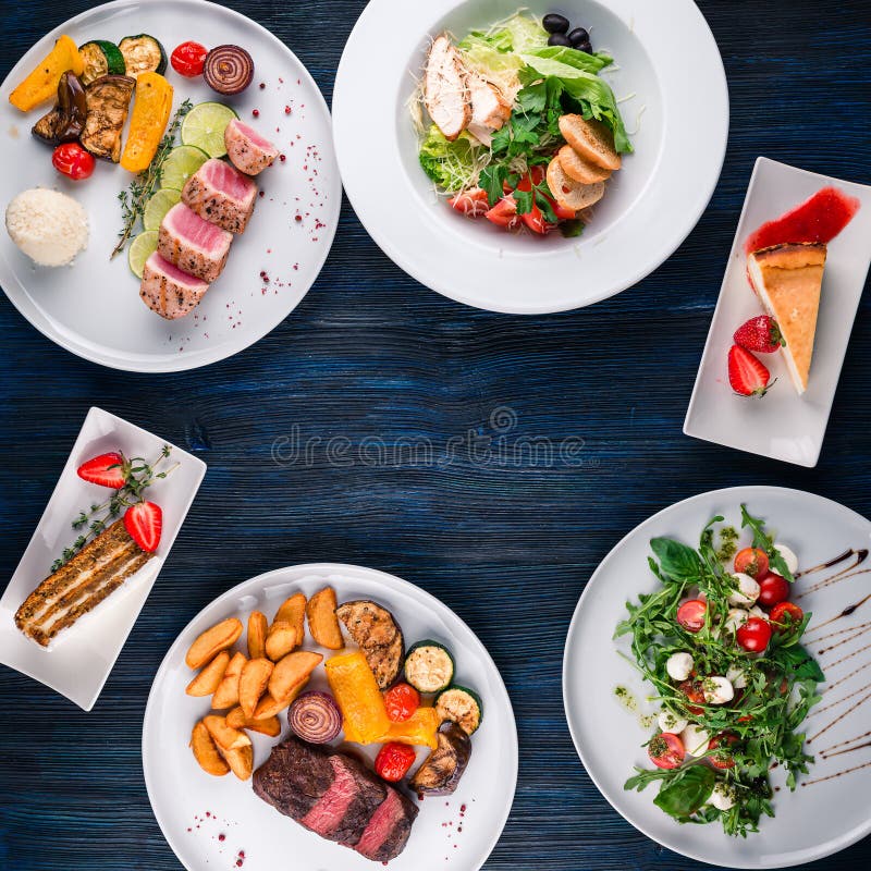 Table Set for Two with a Main Course, Salad and Dessert Stock Photo ...