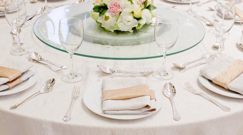 The Table is Set for a Western Style Dinner with Round Glass on Stock ...