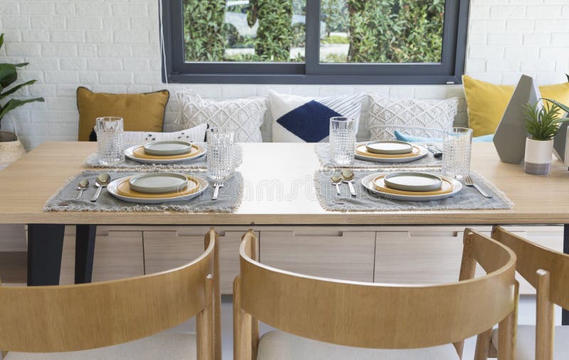 Table Set on Table with Yellow Plate Setting in Modern Style Dining ...