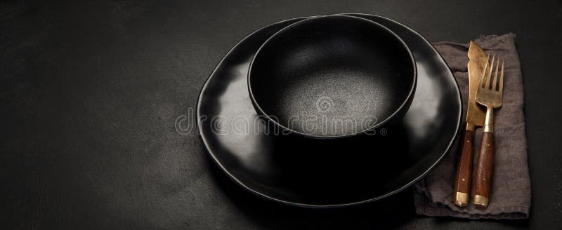 Table Setting with a Black Plates on a Black Background. Minimalism ...