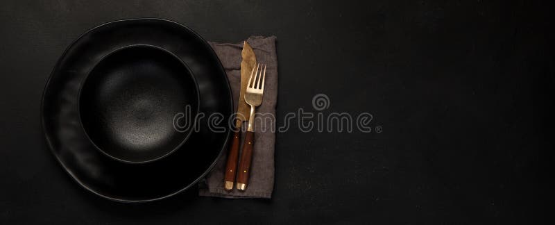 Table Setting with a Black Plates on a Black Background. Minimalism ...