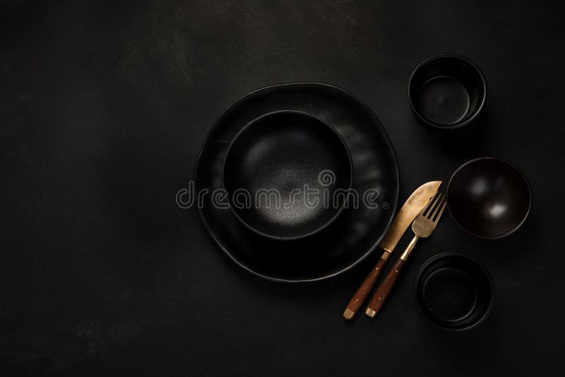 Table Setting with a Black Plates on a Black Background. Minimalism ...