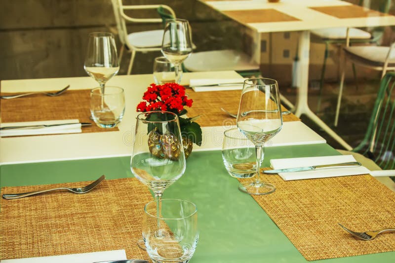 Table Setting with Blank Guest Card on Empty White Plate and Cutlery on ...