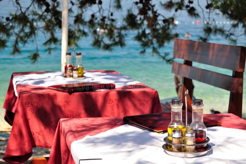 Table Setting with Bottles of Olive Oil and Vinegar at Tropical Beach ...