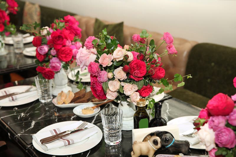 Table Setting with Bouquets of Flowers with Pink and Red Roses on the ...
