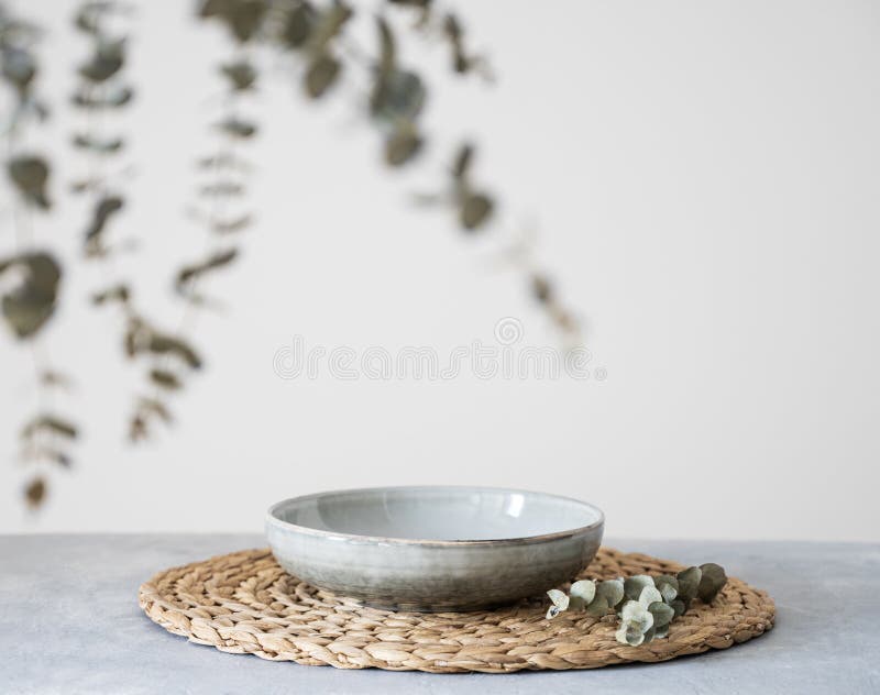 Table Setting with Ceramic Plate and Eucalyptus Branches on Blue ...