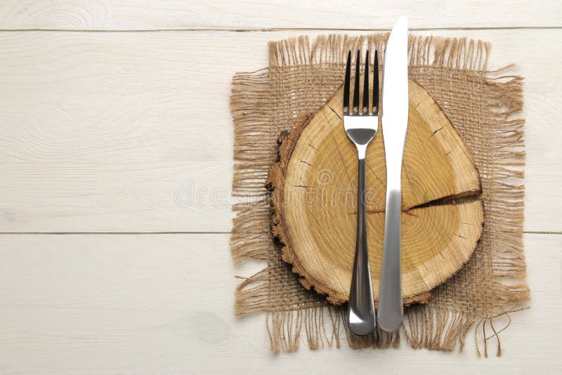 Table Setting. Cutlery. Fork, Knife and Wooden Stand on a White Wooden ...