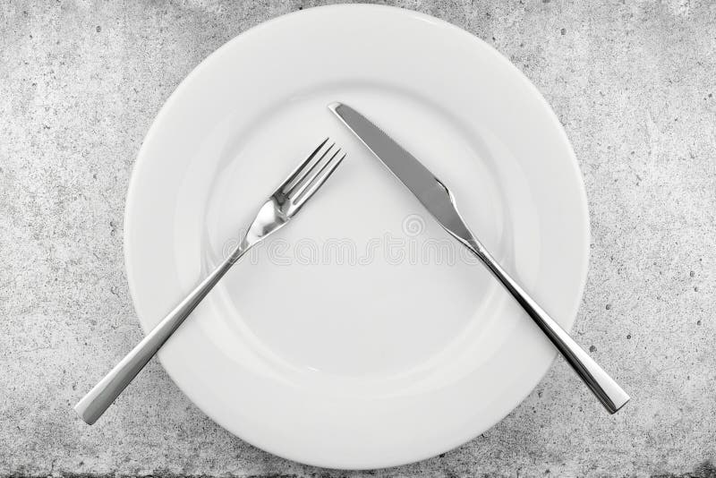 Table Setting. Empty Plate, Knife and Fork on a Light Concrete ...