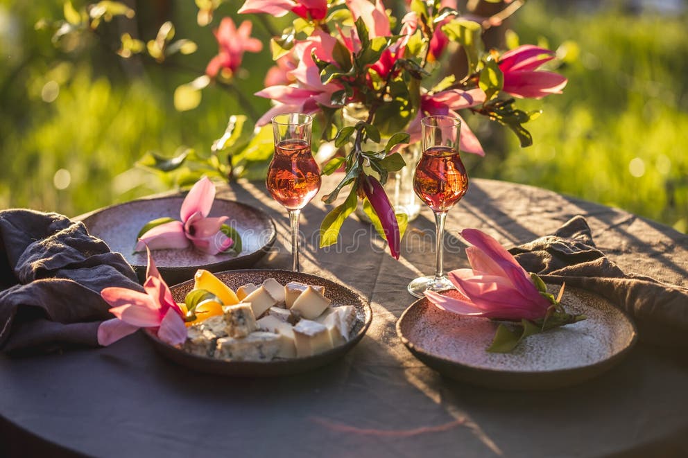 Table Setting in Garden on Sunset Light. Table Decorated with Magnolia ...