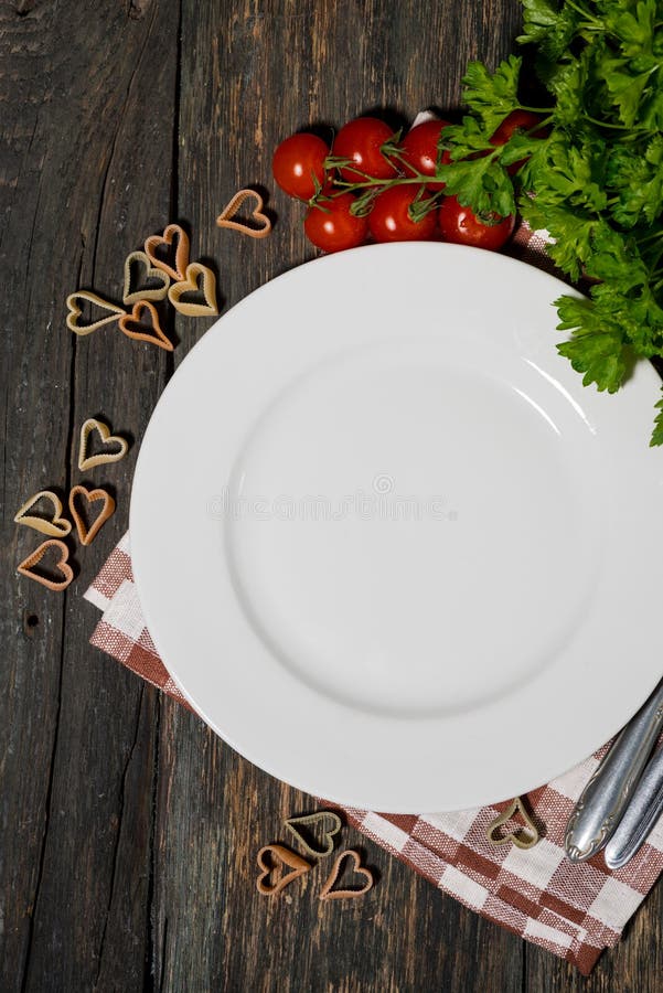 Table Setting with Pasta and Vegetables on Wooden Table, Vertical Stock ...