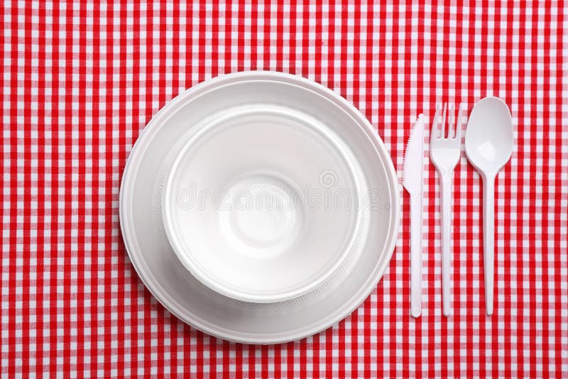 Table Setting with Plastic Dishware on Plaid Fabric Stock Image - Image ...