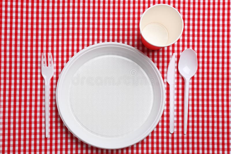 Table Setting with Plastic Dishware on Plaid Fabric Stock Image - Image ...