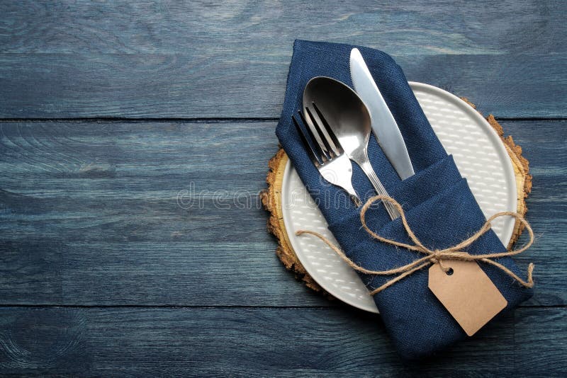 Table Setting. Plate, Glass and Cutlery in a Blue Napkin, Fork, Spoon ... Table Setting. Plate, Glass and Cutlery in a Blue Napkin, Fork, Spoon ...