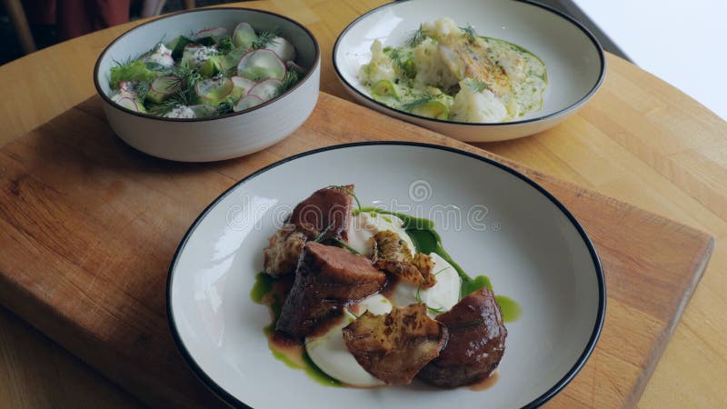 Table Setting. Ready Meals, Meat, Fish and Vegetable Salad on the Table ...