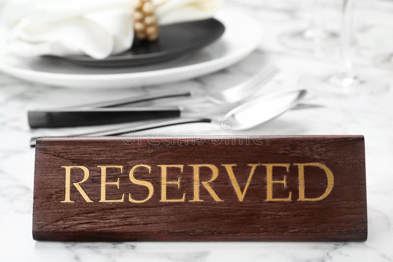 Table Setting with RESERVED Sign Stock Image - Image of plate, blurred ...