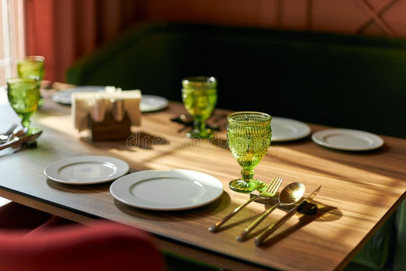 Table Setting in the Restaurant, White Plates, Green Goblet, Wooden ...
