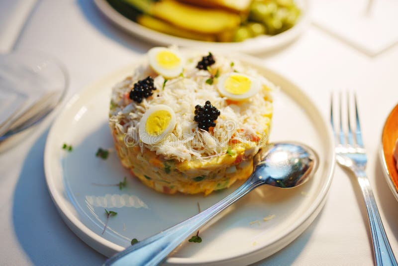 Table Setting. Salad with Seafood and Quail Egg on a Round Plate Stock ...