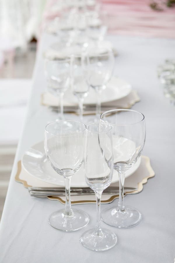 Table Setting with White Tablecloth, Glasses, White Plates Stock Photo ...