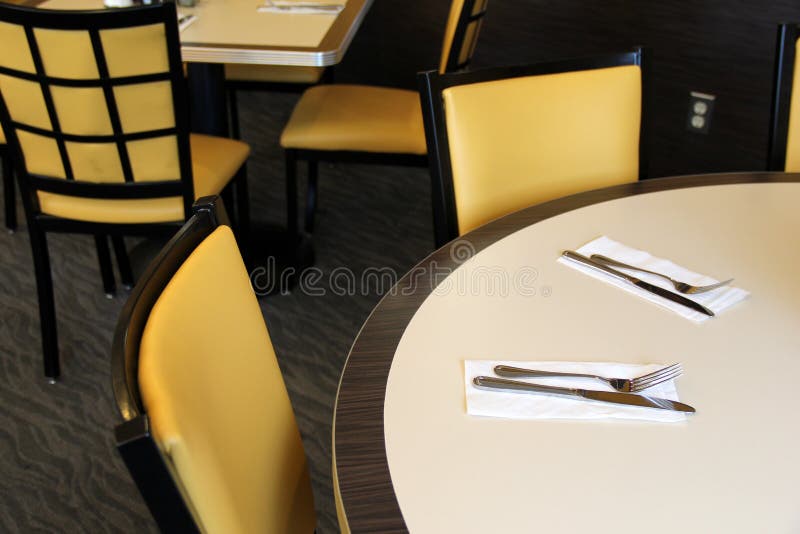 Table Settings and Soft Yellow Chairs at Diner Stock Photo - Image of ...