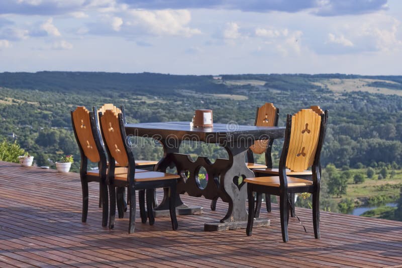 A Table and Several Chairs on a Pedestal, Which Rises on the Mountain ...