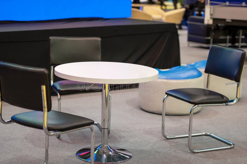 A Table and Several Chairs are in a Room with a Blue Screen Stock Photo ...