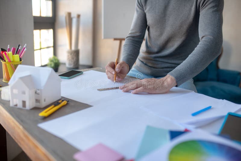 Interior Designer Sitting at the Table and Drawing Sketches Stock Photo ...