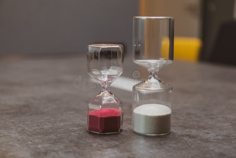 On Table Stand Two Egg Timers of Different Sizes Stock Image - Image of ...