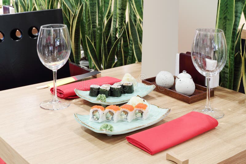 Table with Sushi at Plates and Empty Glasses Stock Photo - Image of ...